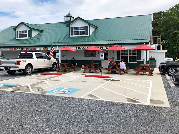 Picnic tables under bright red umbrellas offer the perfect spot for cracking crabs while soaking up Delaware sunshine.