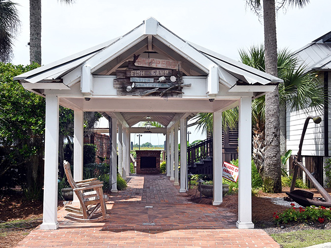 The welcoming covered entrance to Skippers' Fish Camp invites you in like an old friend, promising coastal treasures just beyond those rocking chairs.