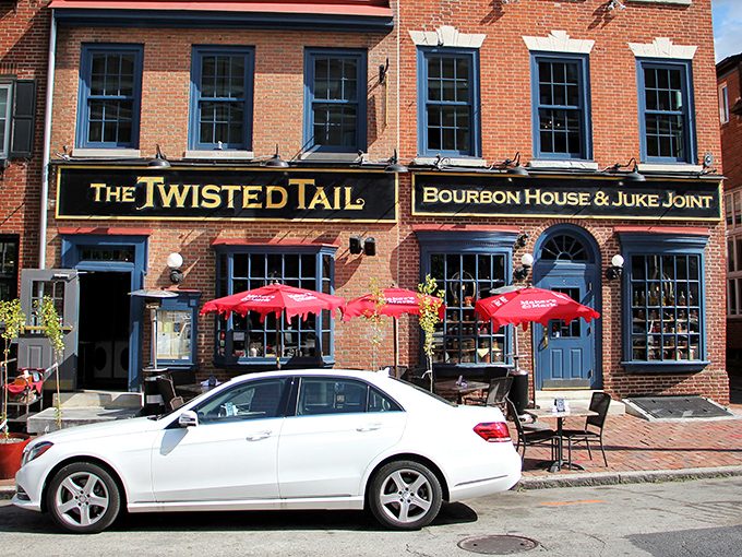 The historic brick fa&ccedil;ade of The Twisted Tail stands proudly on Philadelphia's cobblestone streets, its golden sign promising bourbon adventures within.