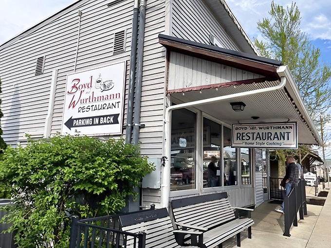 The classic storefront beckons with wooden benches where locals swap stories while waiting for their slice of homemade heaven.