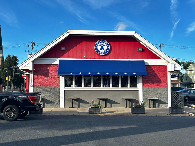 The patriotic red, white, and blue exterior of Liberty Bell Diner stands like a delicious declaration of independence from boring food.