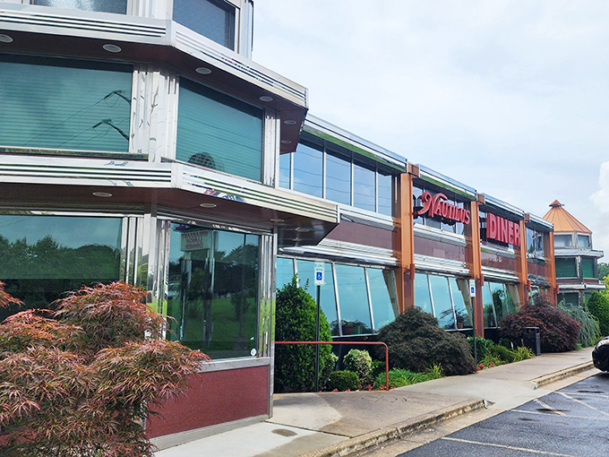 The gleaming chrome and glass exterior of Nautilus Diner stands like a time capsule on Route 3, promising comfort food treasures within.