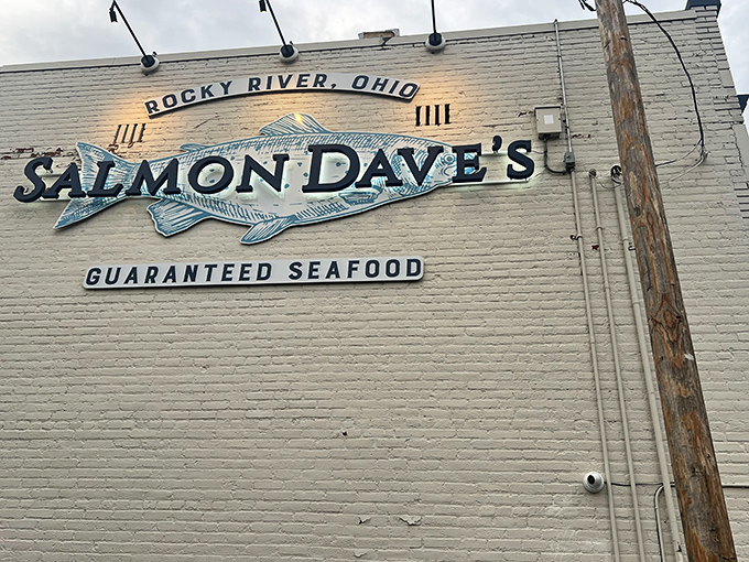 The iconic white brick building of Salmon Dave&rsquo;s promises &ldquo;GUARANTEED SEAFOOD&rdquo; &mdash; a bold claim they back up daily with maritime flair and coastal confidence.