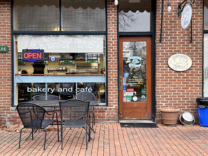 A cozy storefront that promises delicious possibilities, with "bakery and caf&eacute;" proudly displayed beneath an inviting "OPEN" sign that beckons carb enthusiasts.
