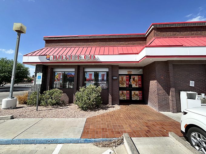 The distinctive red-trimmed roof of Arizona Donut Co. beckons hungry visitors to this unassuming Tempe treasure where breakfast brilliance awaits.