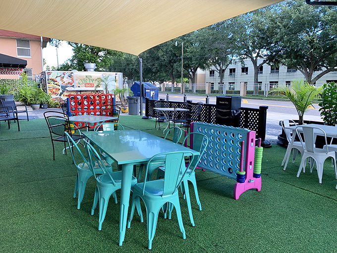 Games and turquoise chairs transform this outdoor space into a community living room where sandwiches are just the beginning of the experience.