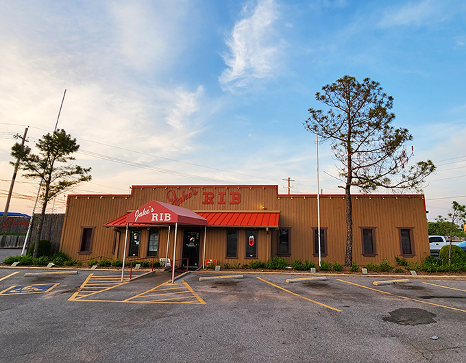 The unassuming wooden exterior of Jake's Rib with its bold red signage promises barbecue greatness without the fancy frills.