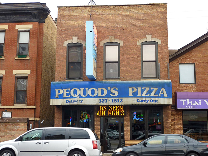 The blue awning beckons like a lighthouse for pizza pilgrims. Pequod's unassuming brick exterior hides Chicago's most addictive caramelized crust within.