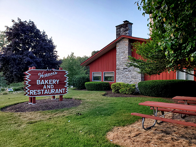 The iconic red barn exterior of Harner's stands like a beacon of comfort food promise along Route 31, complete with picnic tables for sunny day indulgence.