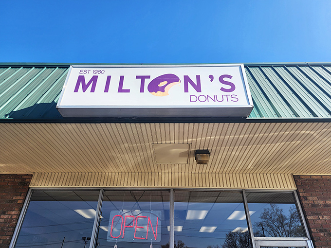 The iconic purple sign announces your arrival at donut paradise, where the logo's bite mark seems to say, "We couldn't wait either."