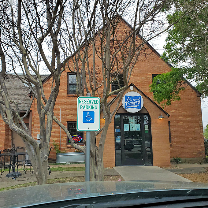 The brick exterior of Blue Bonnet Bakery stands like a temple to carbohydrates, promising sweet salvation within its hallowed walls.