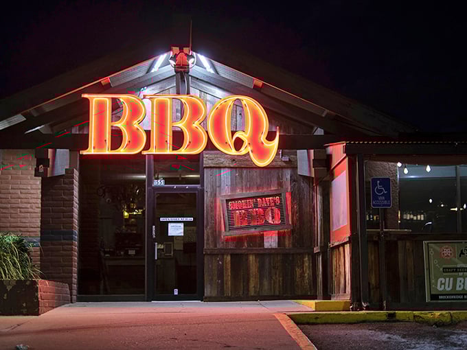 The neon BBQ sign glows like a beacon in the night, promising smoky salvation for the hungry and barbecue-deprived of Denver.