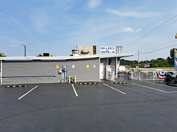 The unassuming gray exterior of Miller's Drive-In stands like a time capsule against the Ohio sky, beckoning hungry travelers with promises of nostalgic delights.