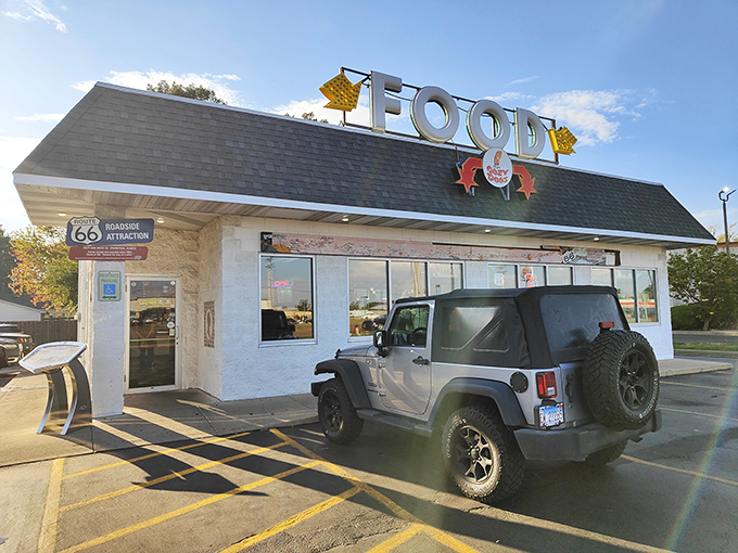 The iconic "FOOD" sign atop Cozy Dog Drive In beckons hungry travelers like a Route 66 lighthouse guiding ships to delicious harbor.