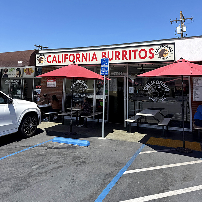 The unassuming storefront with its bold red sign promises exactly what you'll get: life-changing California burritos without the fancy frills.