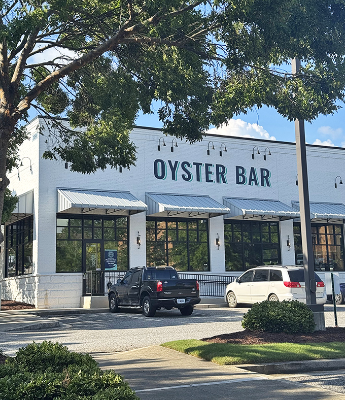 The crisp white exterior of Seaside Oyster Bar stands out like a beacon of hope for seafood lovers stranded in suburban Georgia.
