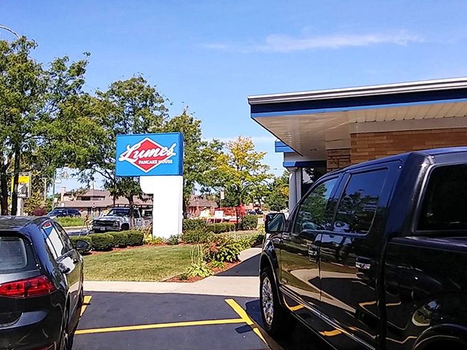 The iconic blue Lumes sign stands like a breakfast lighthouse, guiding hungry Chicagoans to pancake paradise through all seasons.