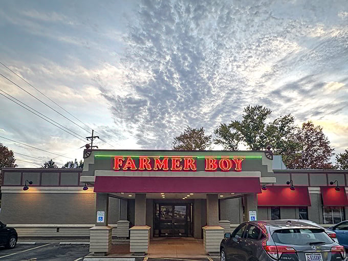 The iconic red Farmer Boy sign against a dramatic Ohio sky promises comfort food salvation for hungry travelers and locals alike.