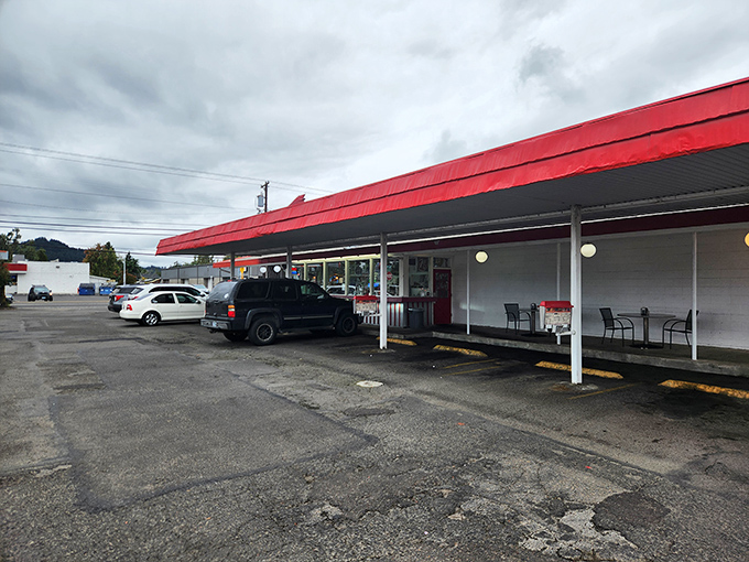 The iconic red awning of Fins Drive-In stands as a beacon of comfort food promise against Oregon's often-gray skies.
