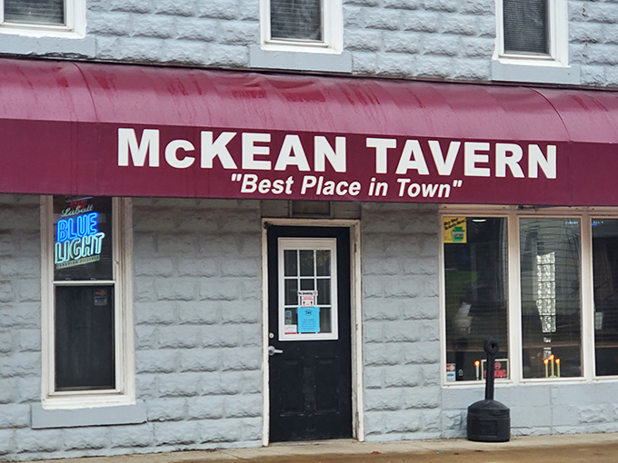 The blue stone exterior with its bold red awning doesn't whisper, it announces: "Best Place in Town." Spoiler alert: they might be right.