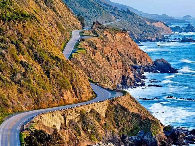 Nature's own roller coaster carved into mountain granite, where every turn reveals another postcard moment waiting to be captured.