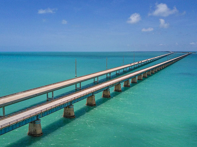 The engineering marvel stretches before you like a thin ribbon of concrete, seemingly floating between two impossibly blue worlds.