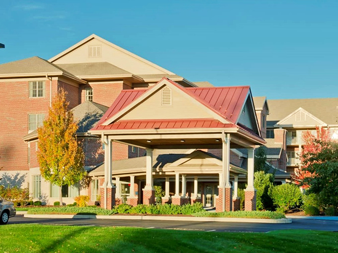 The welcoming entrance to Bethany Village stands proud with its signature red roof, like a five-star resort that happens to be your home.