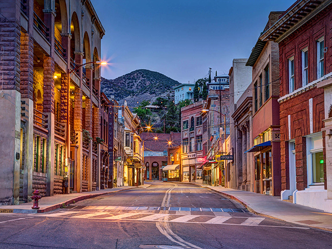 Bisbee's Main Street at twilight looks like a movie set where the Wild West meets bohemian charm. Those mountains aren't just scenery—they're keeping watch.