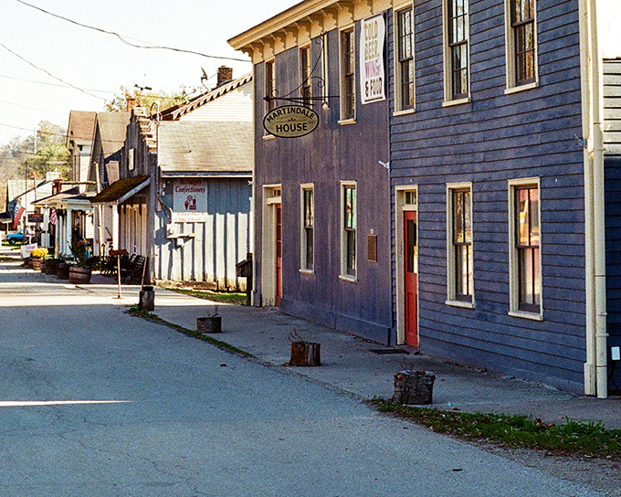The Martindale House stands sentinel on Metamora's quiet street, its weathered blue siding holding more stories than your favorite history podcast.
