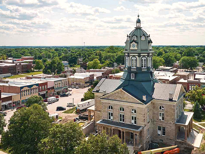 The Madison County Courthouse dominates Winterset's skyline, its distinctive dome standing watch over a town where retirement dollars stretch like saltwater taffy.