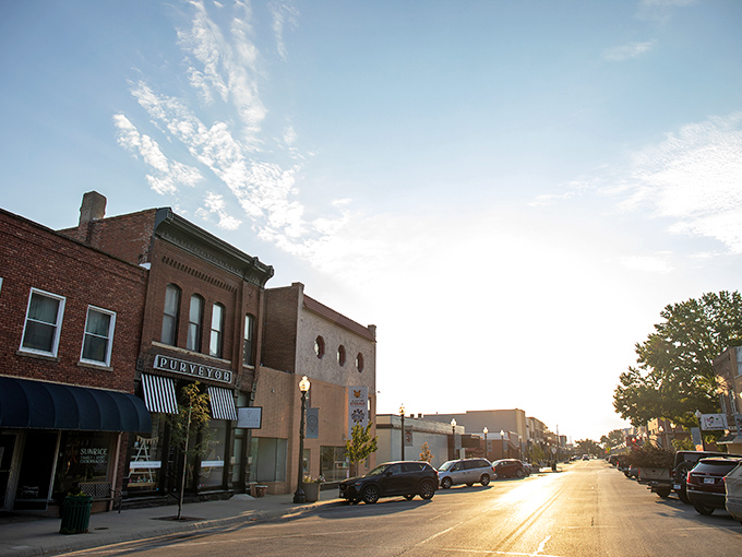 Golden hour transforms Atchison's historic Commercial Street into a Norman Rockwell painting come to life, where brick storefronts tell stories of generations past.