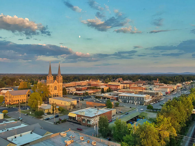 Cullman's skyline at golden hour showcases those iconic twin spires of Sacred Heart Church watching over a downtown that feels like small-town America perfected.