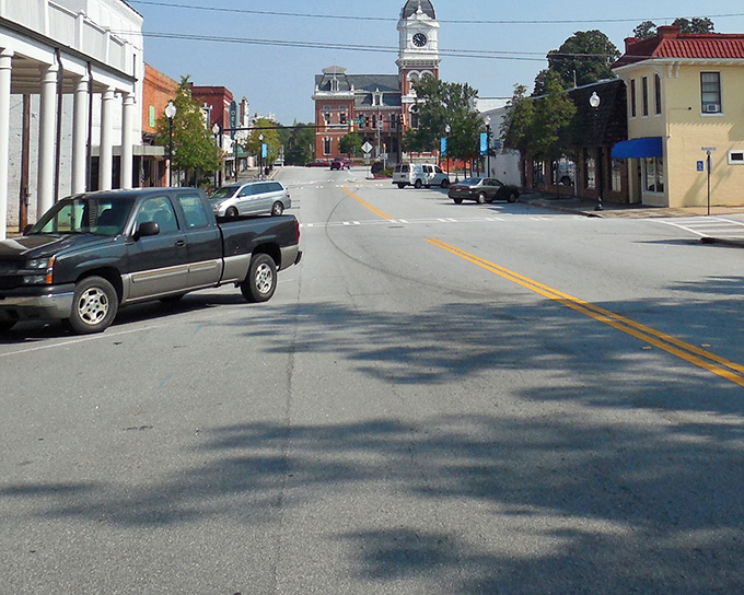 Looking down Covington's main street, where that iconic courthouse clock tower stands like a sentinel guarding small-town charm that's increasingly rare these days.