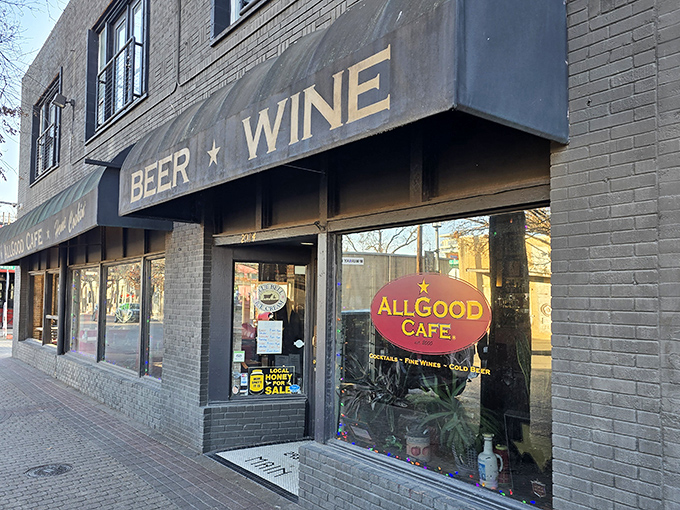 The unassuming storefront that houses culinary magic &ndash; Allgood Cafe's exterior promises what its name delivers, with "BEER ★ WINE" signage that whispers, "Stay awhile."