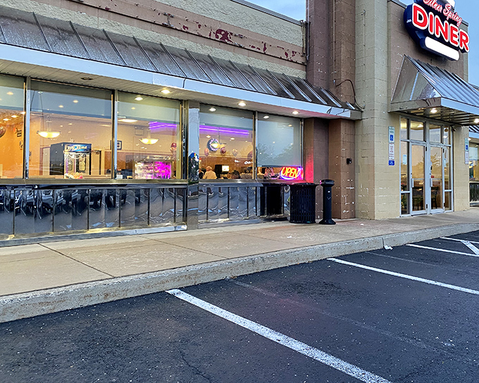 The classic neon sign beckons hungry travelers like a lighthouse for the breakfast-obsessed. This unassuming exterior hides culinary treasures within. 