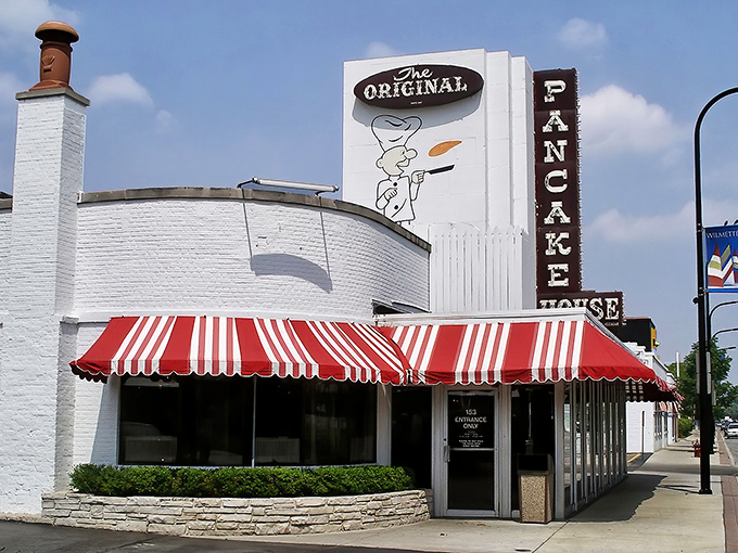 The iconic white building with its cheerful red and white awning stands like a beacon of breakfast hope on Wilmette's streetscape.