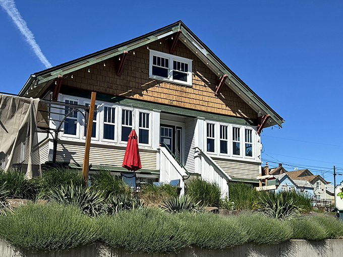 Craftsman charm meets culinary haven. This cedar-shingled bungalow with its welcoming porch practically whispers "come hungry, leave happy" to passersby.