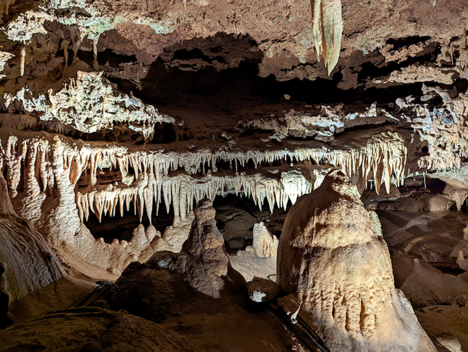Nature's own chandelier display! These delicate stalactites hang from the ceiling like limestone icicles frozen in geological time.