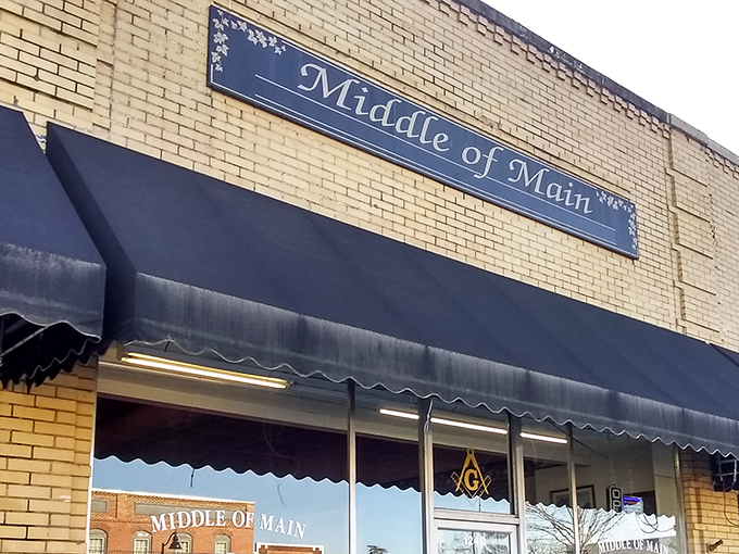The inviting yellow brick fa&ccedil;ade of Middle of Main beckons treasure hunters with its classic navy awnings and small-town charm.