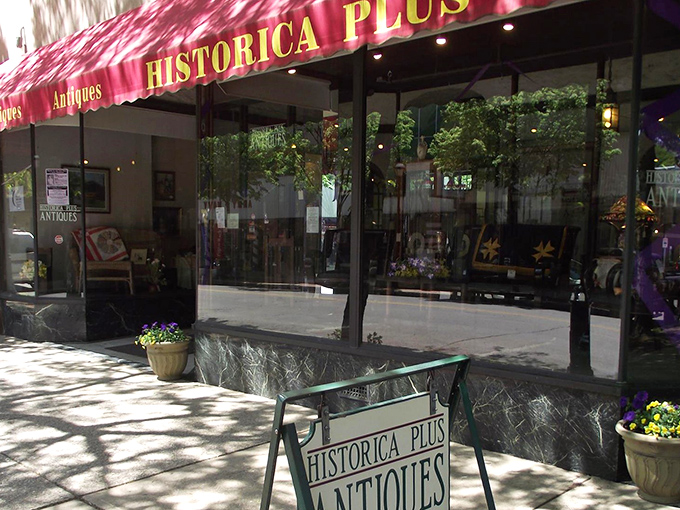 The iconic red awning of Historica Plus beckons like a portal to the past, promising treasures beyond the glass.