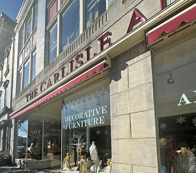 The iconic red awning of Carlisle Antique Mall beckons treasure hunters like a lighthouse for the nostalgically inclined.
