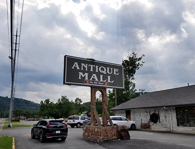The iconic stone-based sign stands like a sentinel, promising treasures within. Against that perfect Tennessee blue sky, it's practically begging you to pull over.