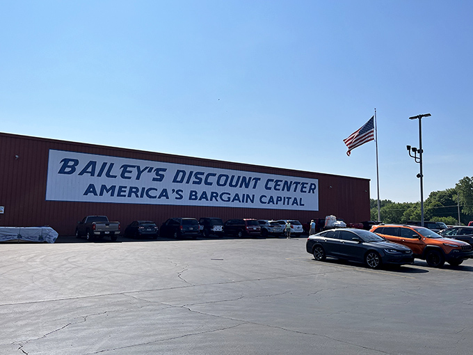 The bold proclamation of "America's Bargain Capital" isn't just marketing&mdash;it's a promise that awaits under that expansive red exterior. The American flag stands sentinel over bargain paradise.