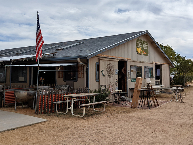 The main building stands like a desert oasis for bargain hunters, complete with American flag and picnic tables for when treasure hunting requires refueling.