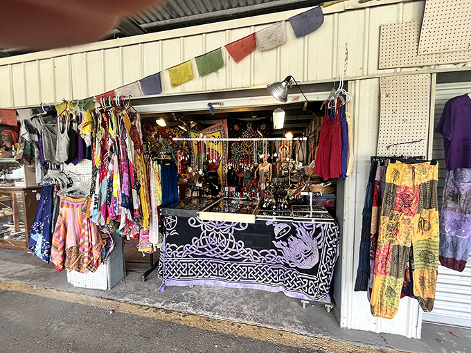 A vibrant vendor stall bursts with colorful fabrics and bohemian fashion, like a portal to a more interesting closet than the one at home.