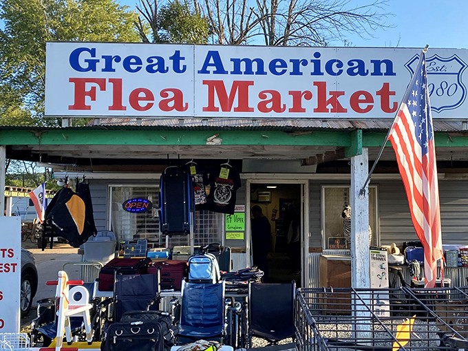 The iconic sign beckons treasure hunters like a siren call. American flags flutter alongside everyday treasures waiting to be discovered.