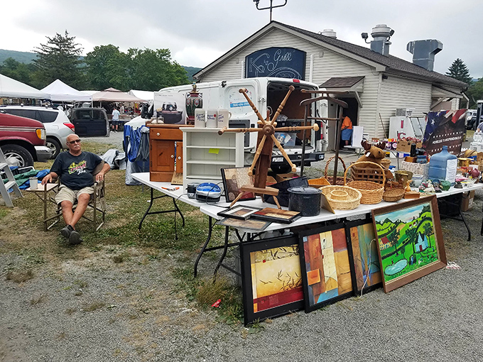 One vendor's treasure trove awaits discovery, with ship's wheel, framed artwork, and vintage furniture creating a microcosm of Pennsylvania's collective attic.