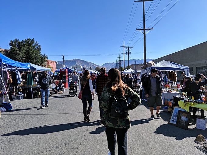 Treasure hunters navigate the Urban Flea Market's open area, where blue tents house everything from vintage oddities to handcrafted wonders.