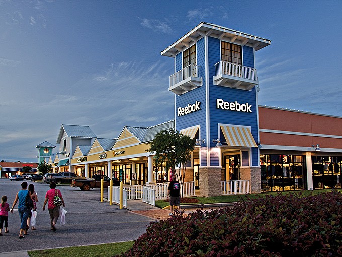 The distinctive coastal-inspired architecture of Tanger Outlets Foley welcomes shoppers to a day-long retail adventure under Alabama's blue skies.