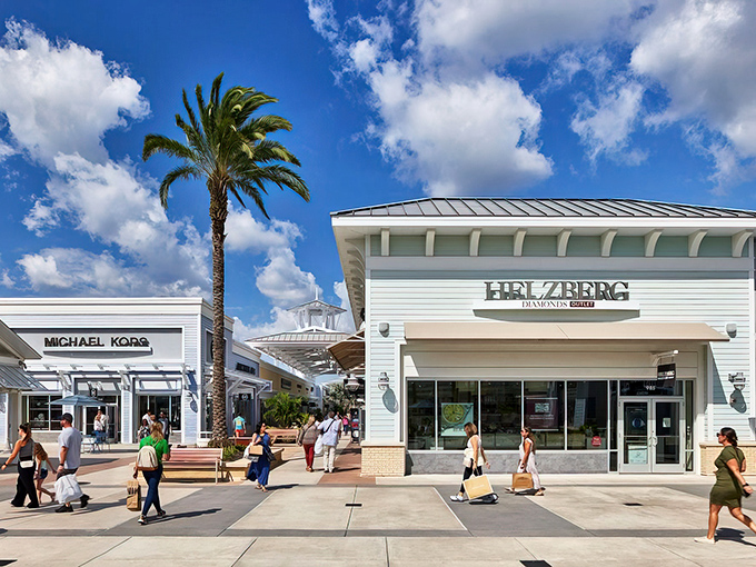 The white-washed storefronts and swaying palms create a shopping oasis that feels more vacation than errand.